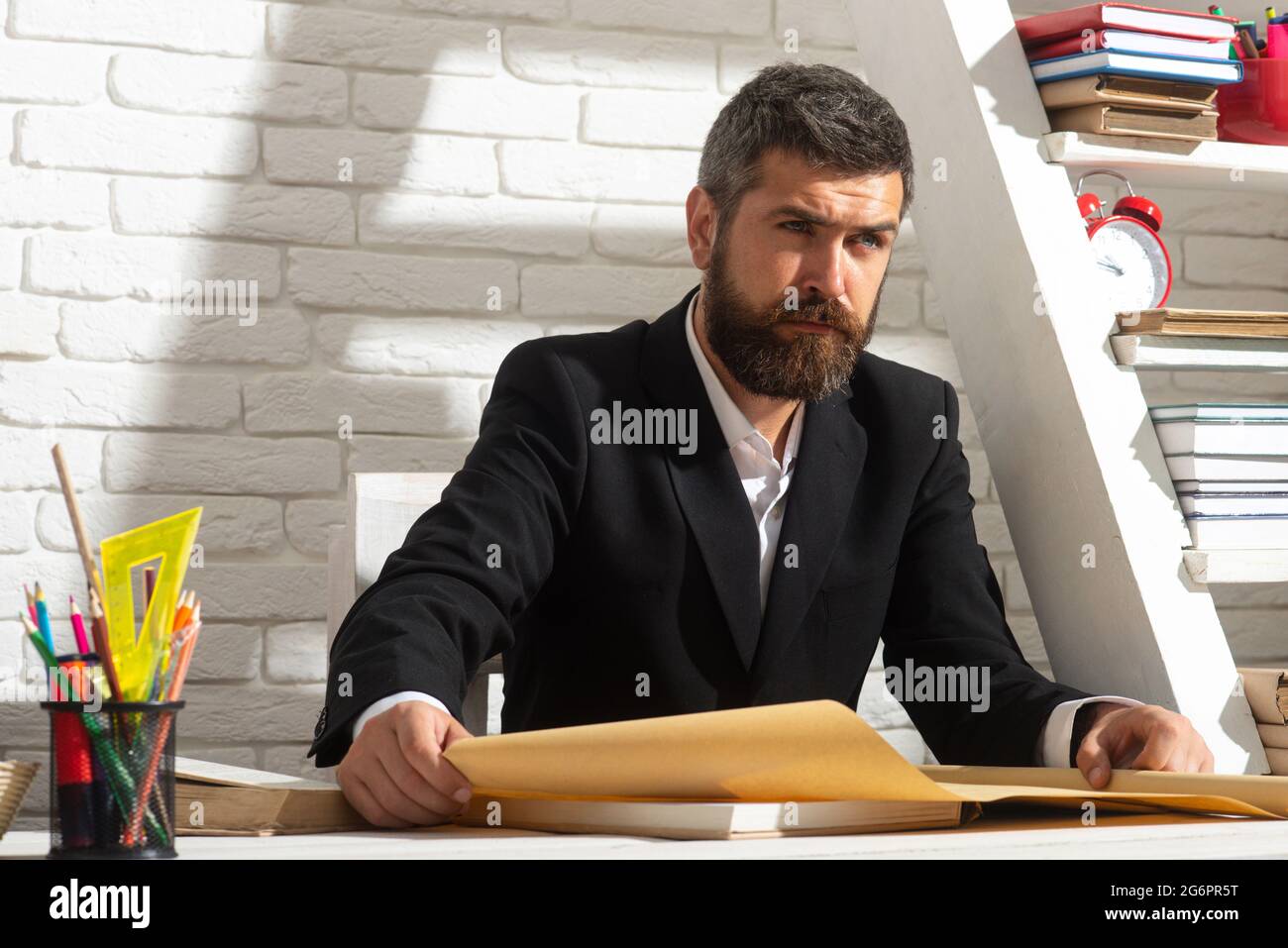 Portrait of serious teacher in school classroom. Tutor, professor ...