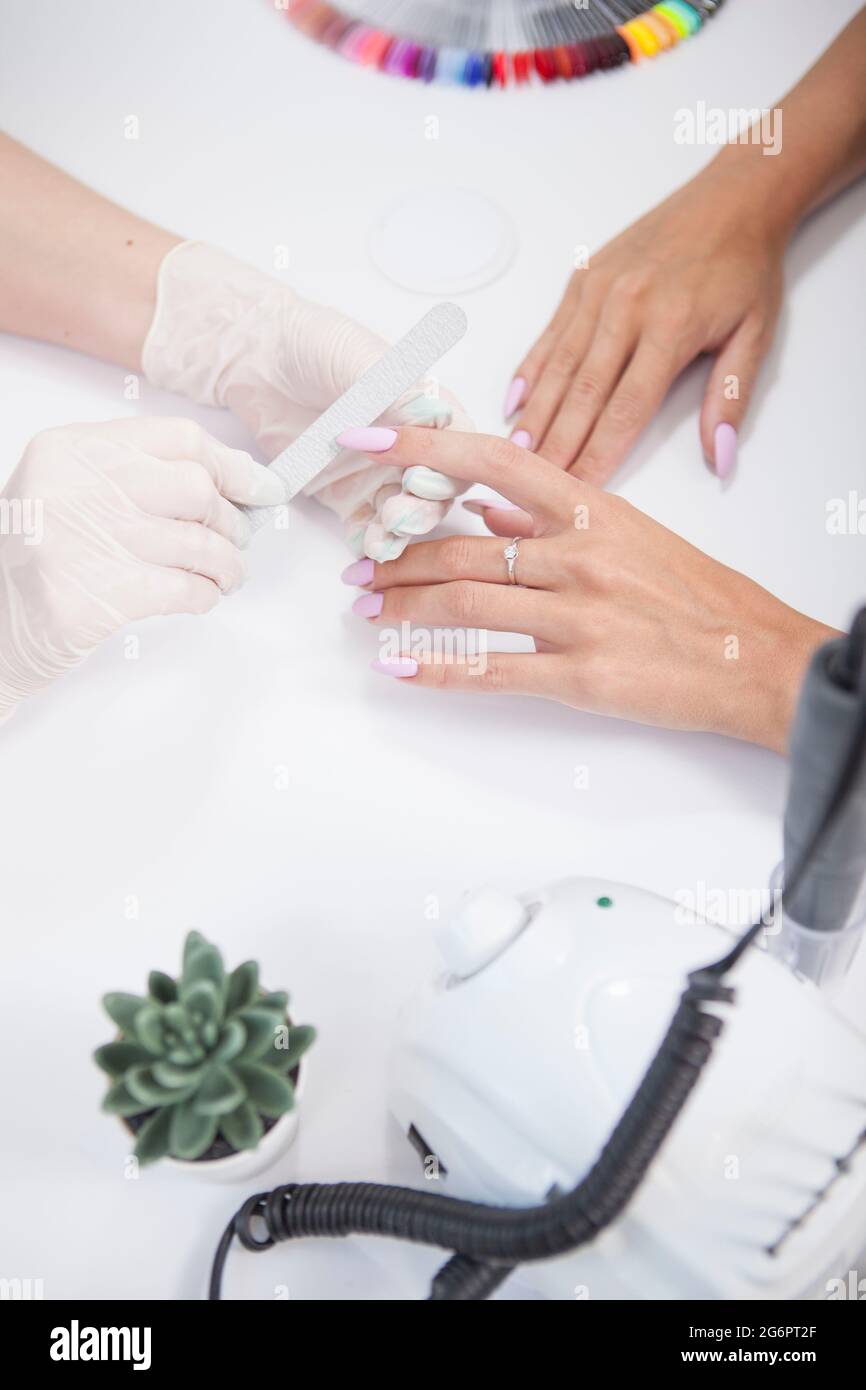 Hand getting manicure technician hi-res stock photography and images ...