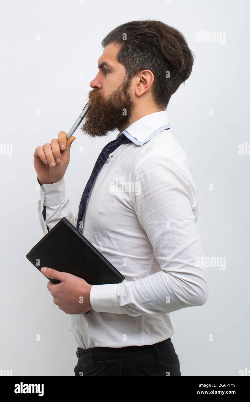 Business man with pen in his mouth. Male with notepad for writing ...