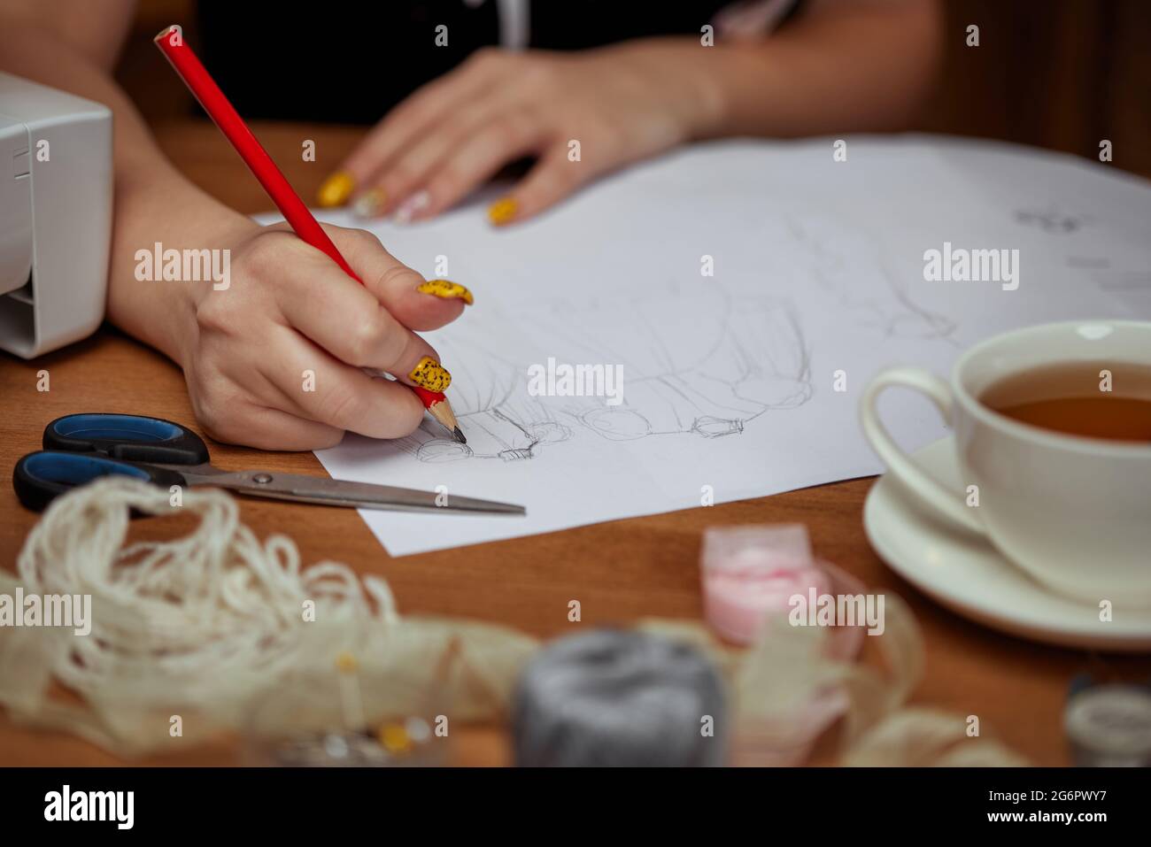Fashion designer drawings with a pencil sketches Stock Photo - Alamy