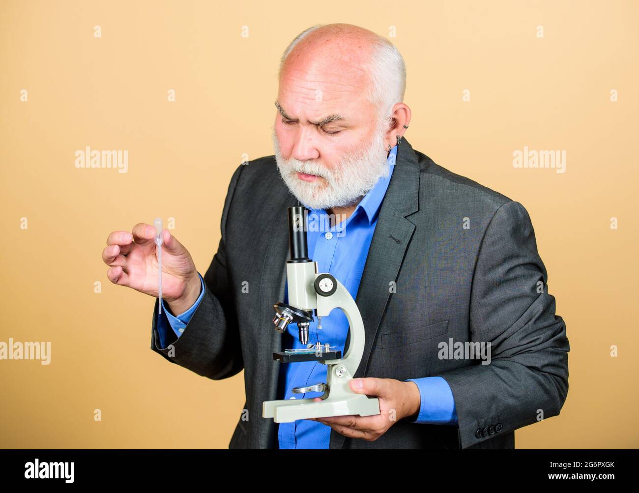 It is unbelievable. mature bearded teacher with microscope. senior man ...