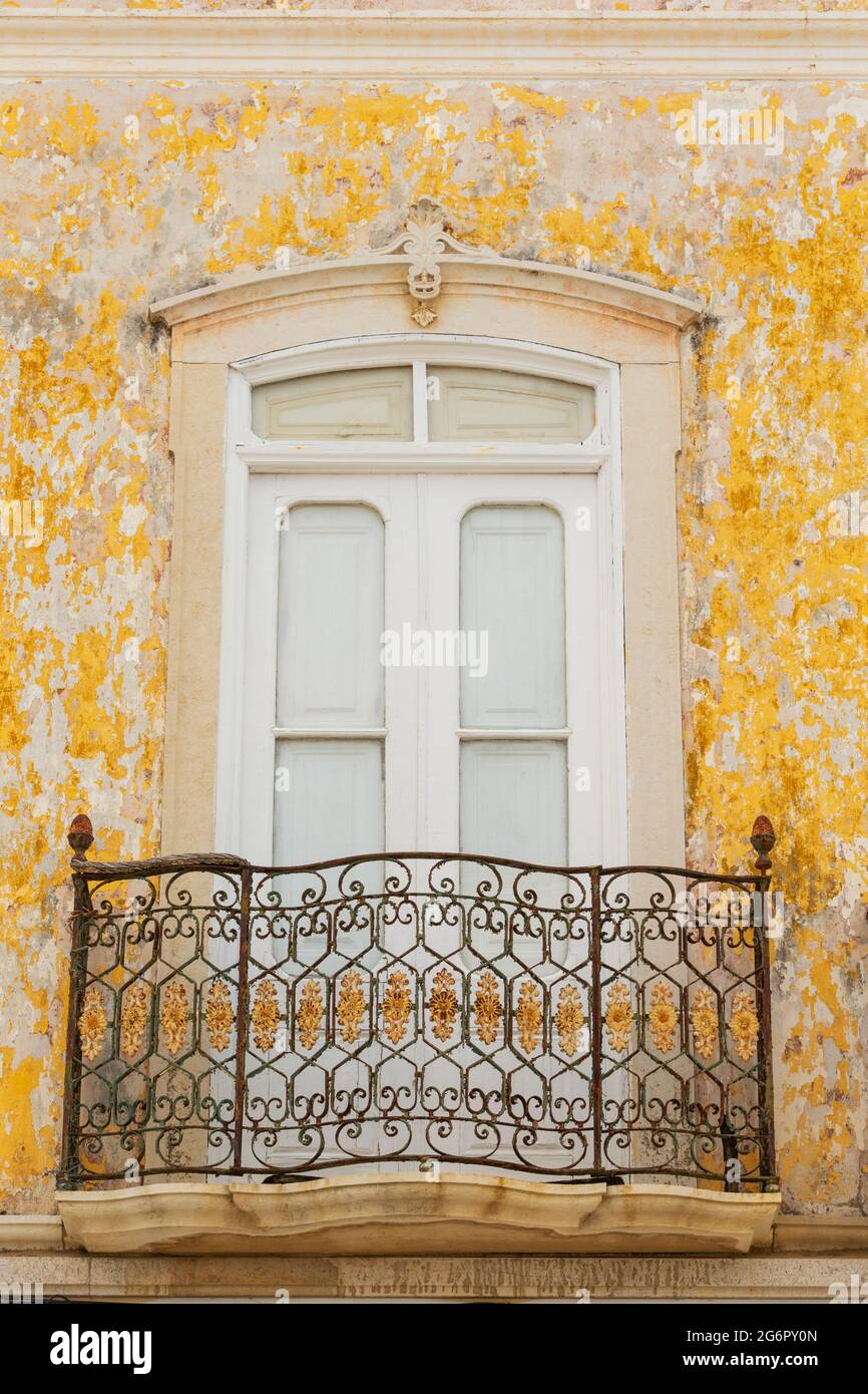 Portrait view of a large window with a veranda surrounded by a ...