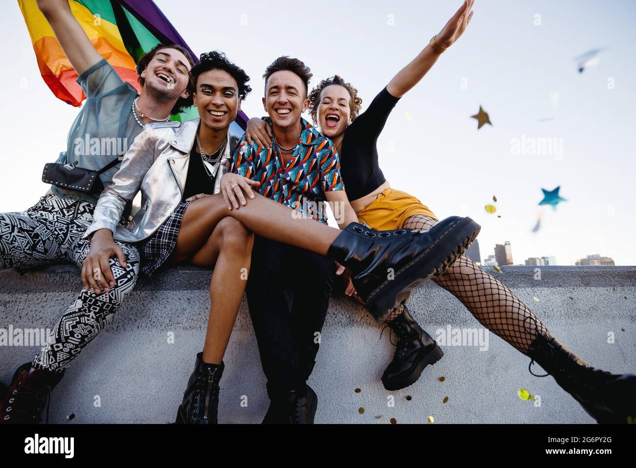 Members of the LGBTQ+ community celebrating pride while sitting ...