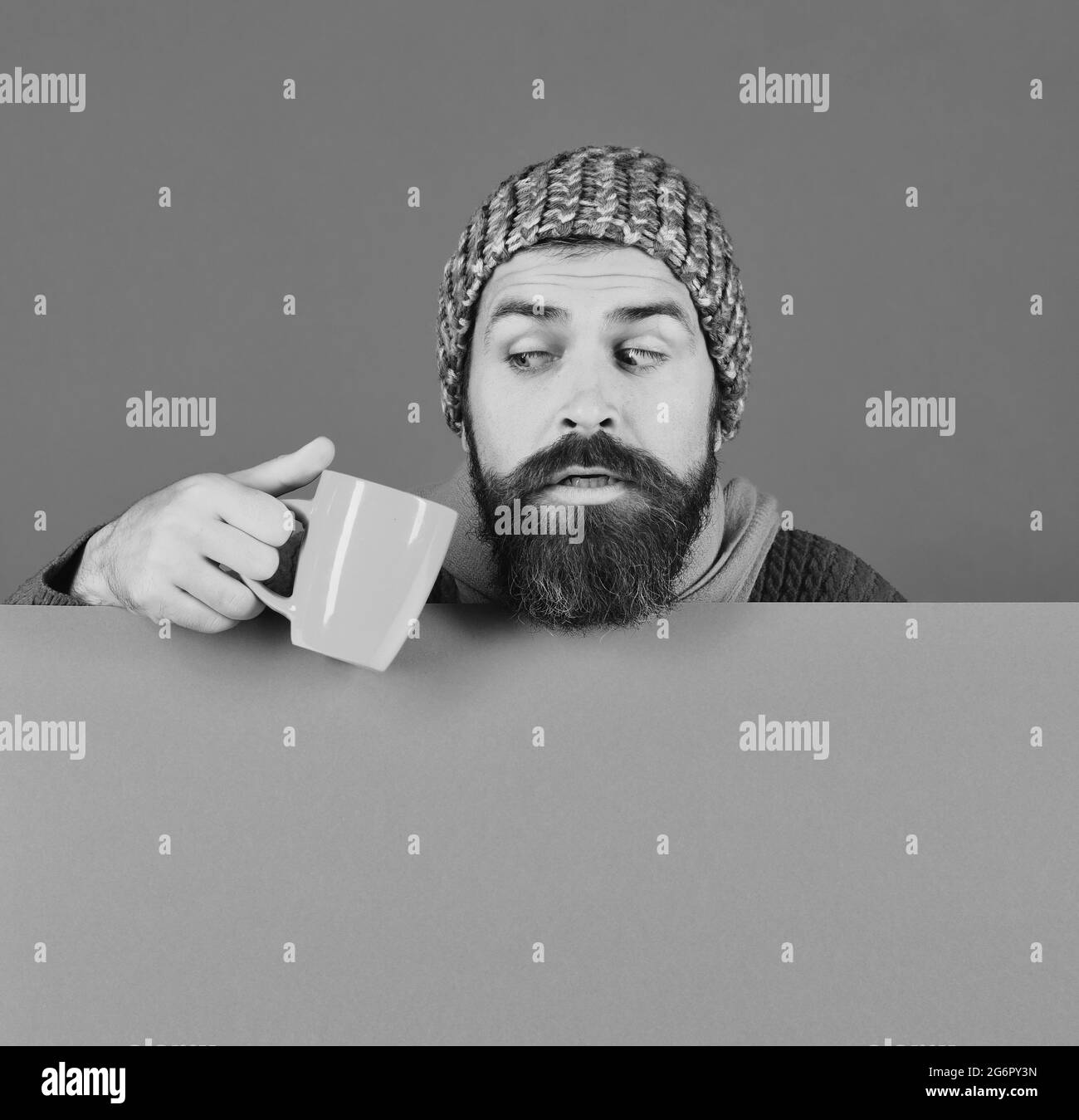 Guy with curious face on green and cyan background Stock Photo - Alamy