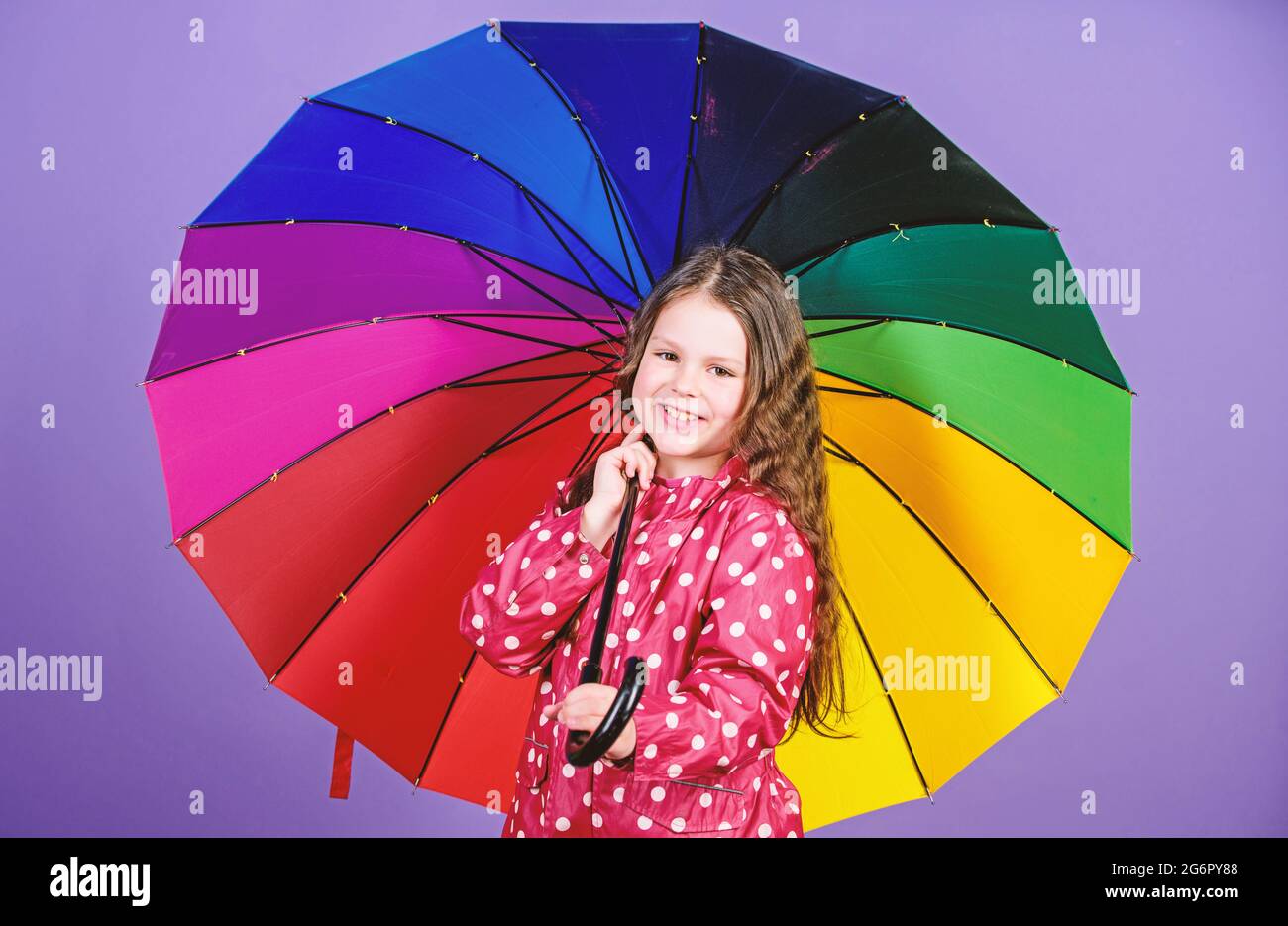 autumn fashion. little girl in raincoat. rain protection. Rainbow ...