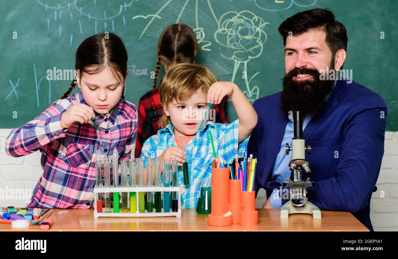 Little kids learning chemistry in school laboratory. school kids ...