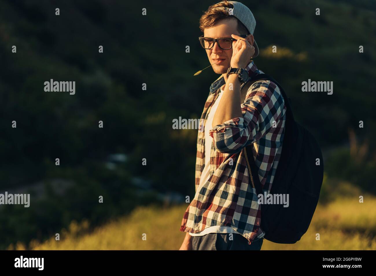 Male tourist on the top of the mountain at sunrise, Young handsome guy ...