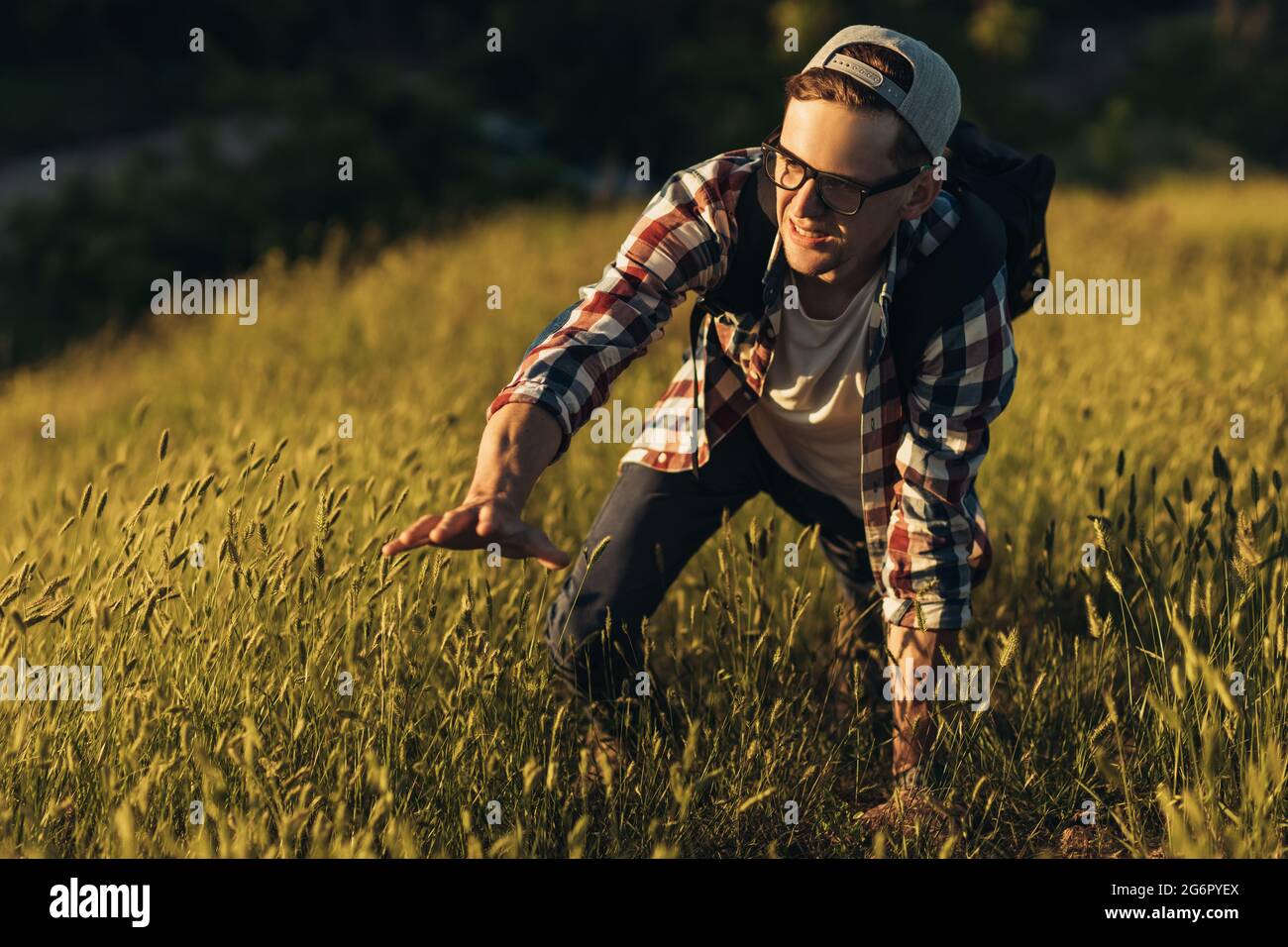 Tourist climbing to the summit, Young man climbing a mountain, Climber ...