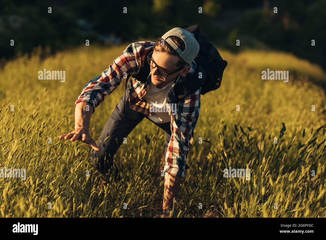 Tourist climbing to the summit, Young man climbing a mountain, Climber ...
