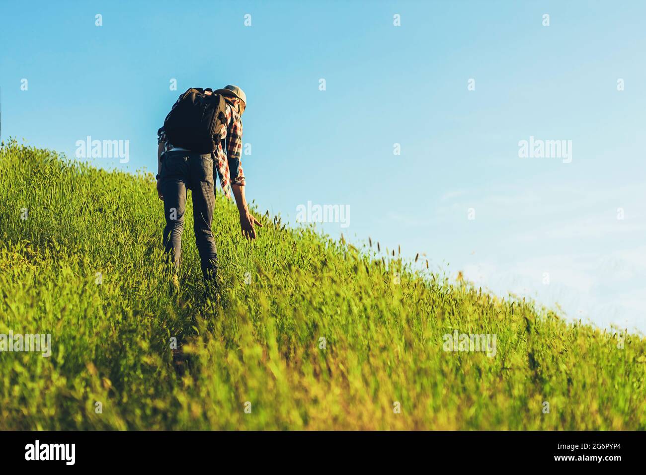 Tourist climbing to the summit, Young man climbing a mountain, Climber ...