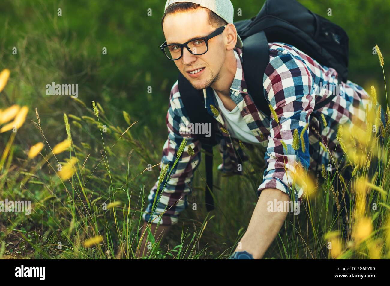 Tourist climbing to the summit, Young man climbing a mountain, Climber ...