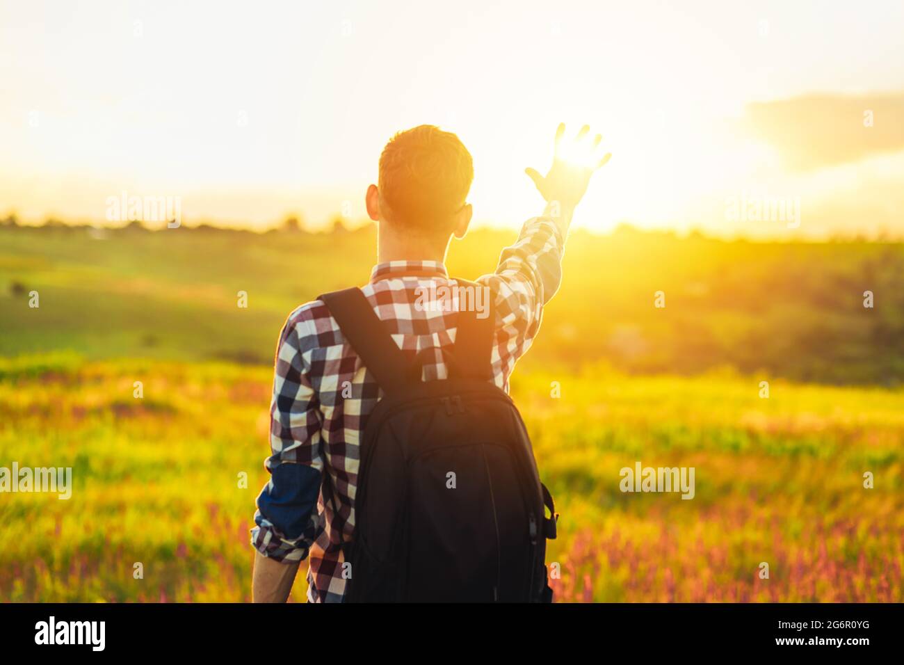 Back view, Human hand, tourist covering sunlight, Sun shining through ...