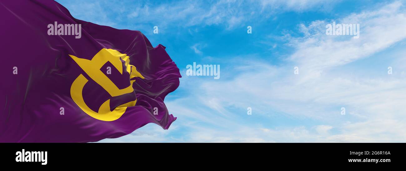 official flag of Okayama prefecture waving in the wind on flagpoles ...