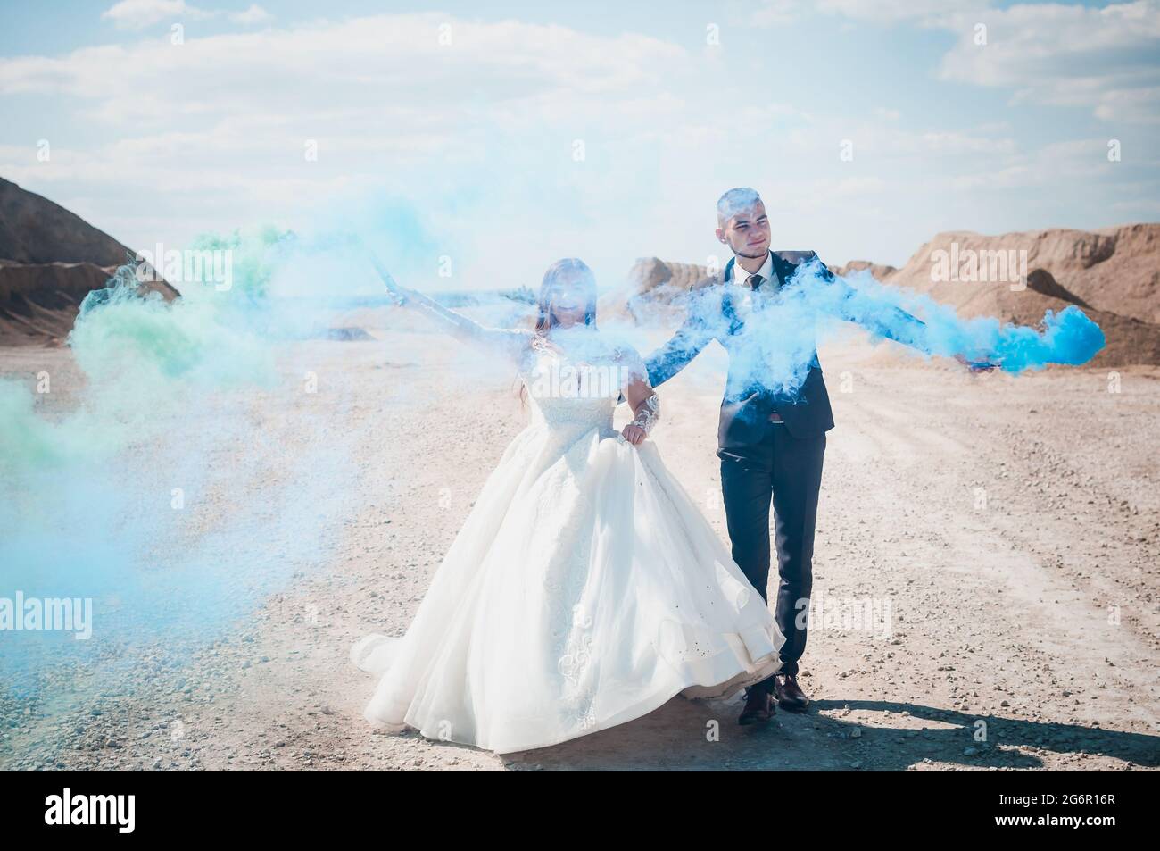 The guy and the girl hug and hold colored smoke in their hands Stock ...