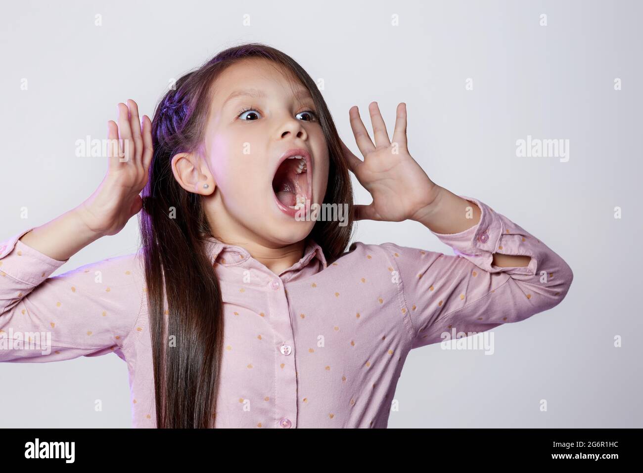 surprised little child girl on white background Stock Photo - Alamy