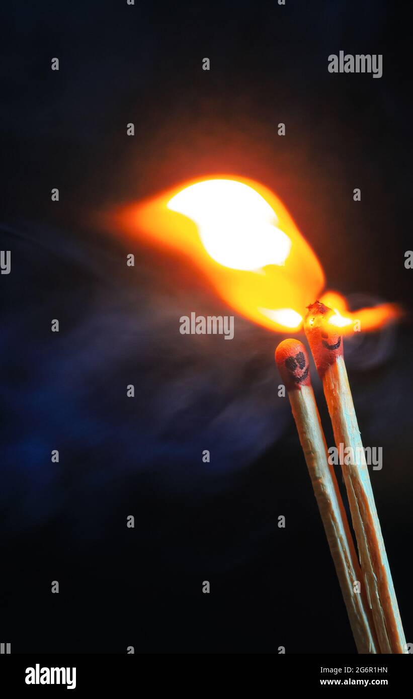 A couple of matches burning together with heat flame isolated on a ...