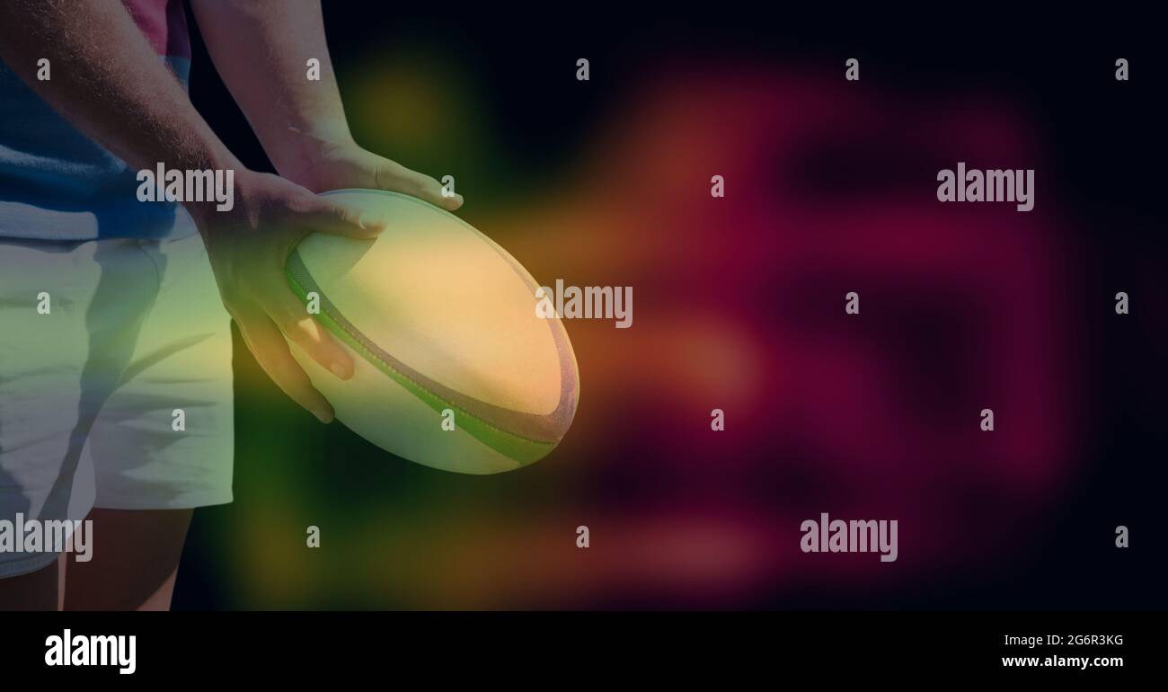 Composition of glowing yellow and red blur over male rugby player ...