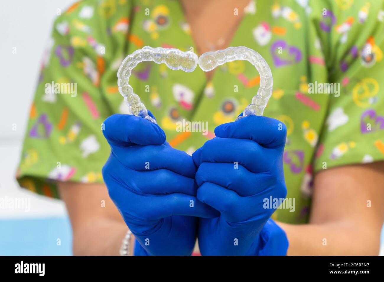 Woman doctor doctor making heart shape with teeth aligners Stock Photo ...