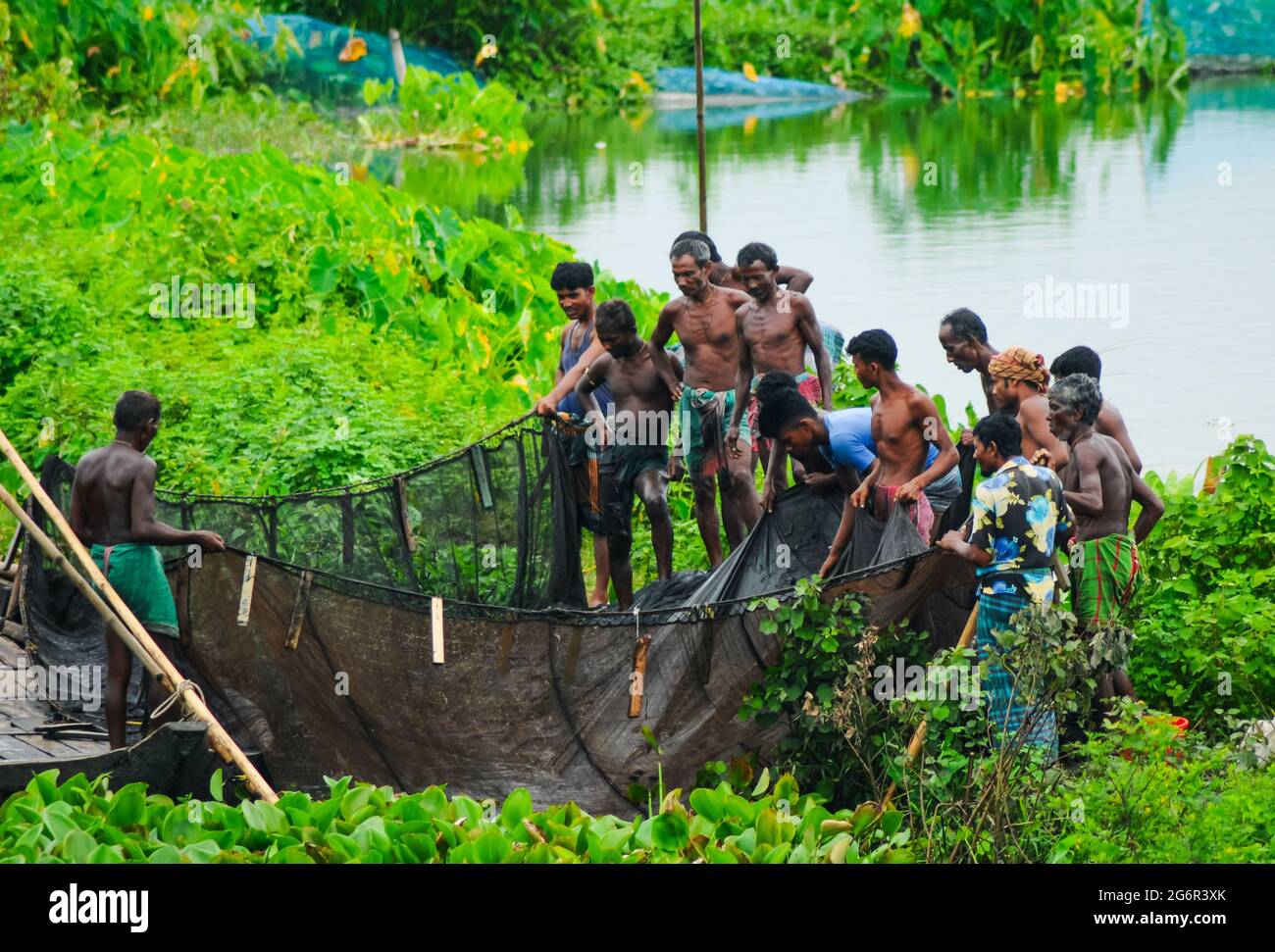 Bangladeshi fishermen caught fish with fishing nets. Fishing on the ...