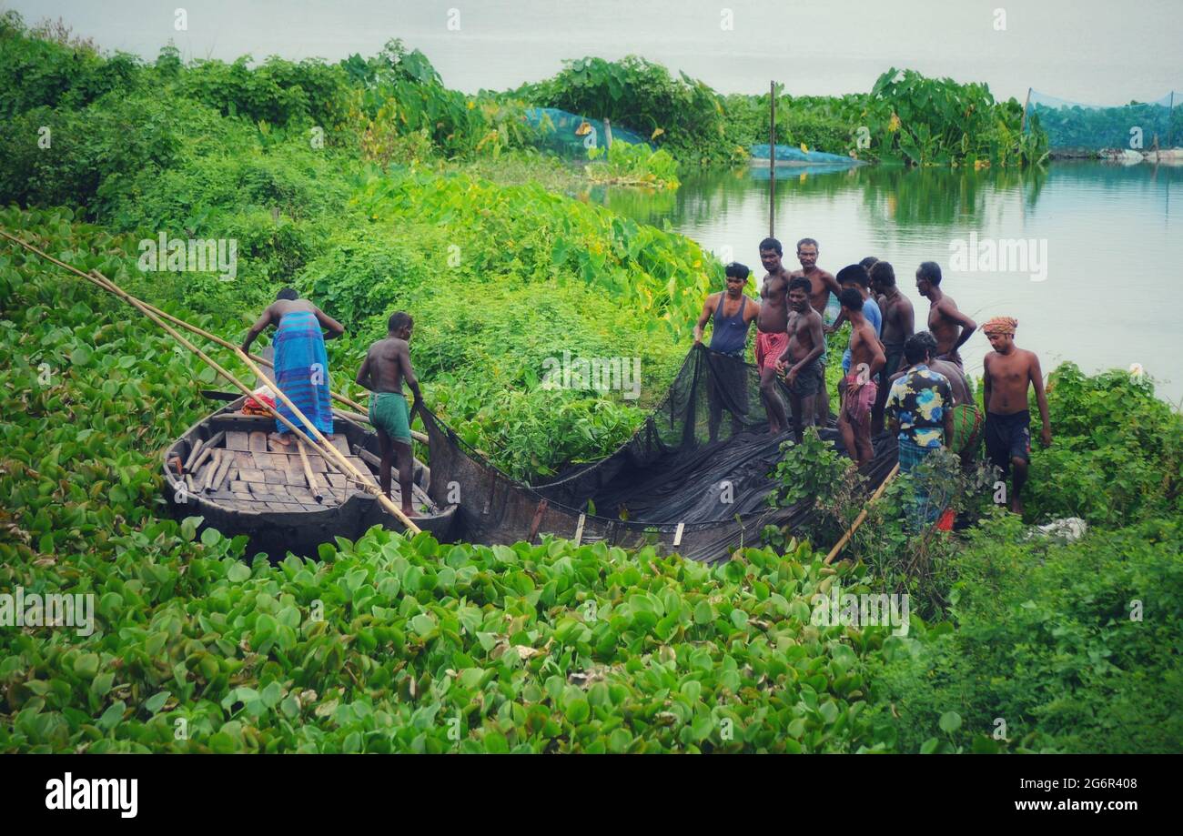 Bangladeshi fishermen caught fish with fishing nets. Fishing on the ...