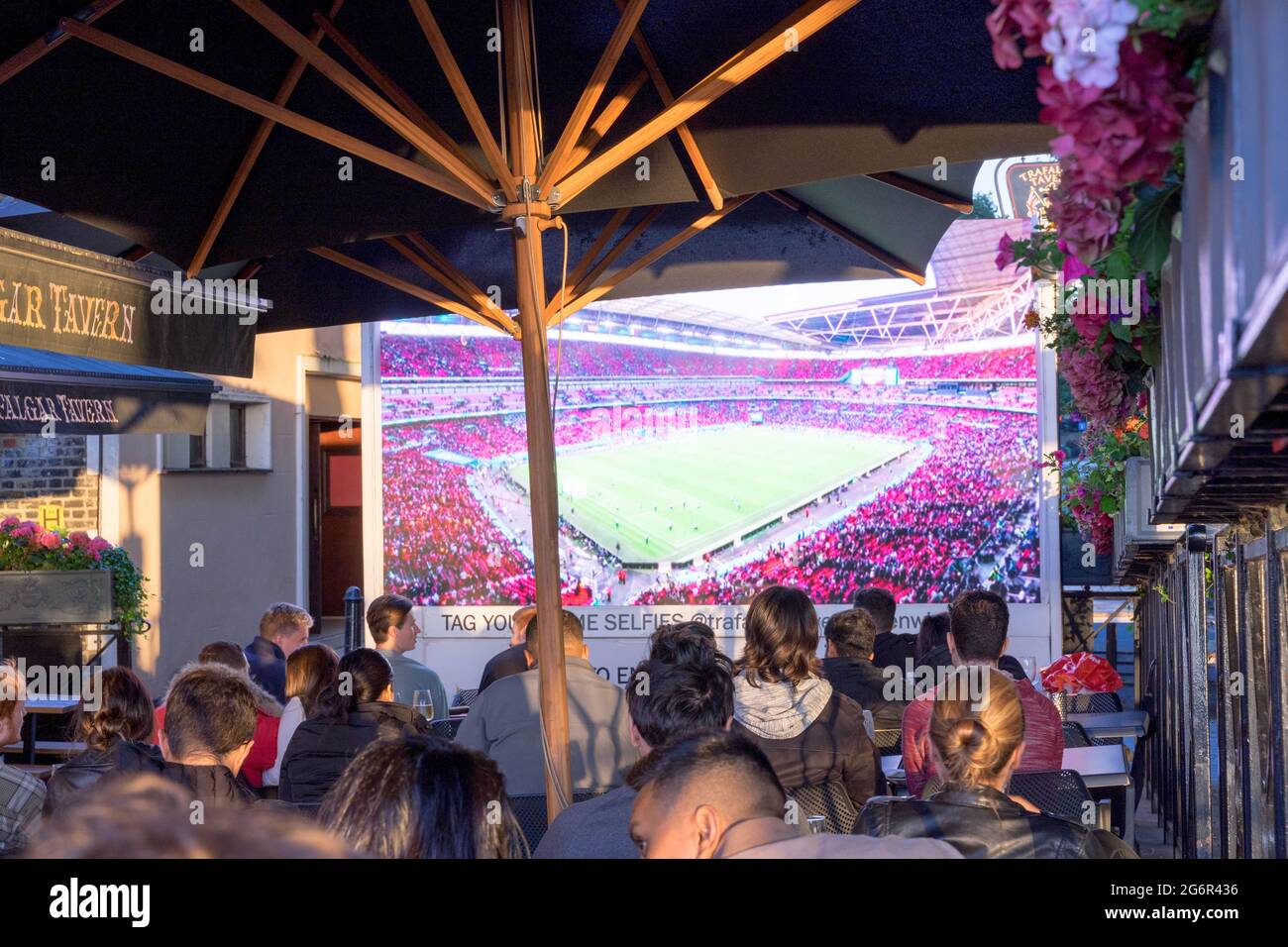 people watching euro 2020 football match at outdoor pub seating, London ...
