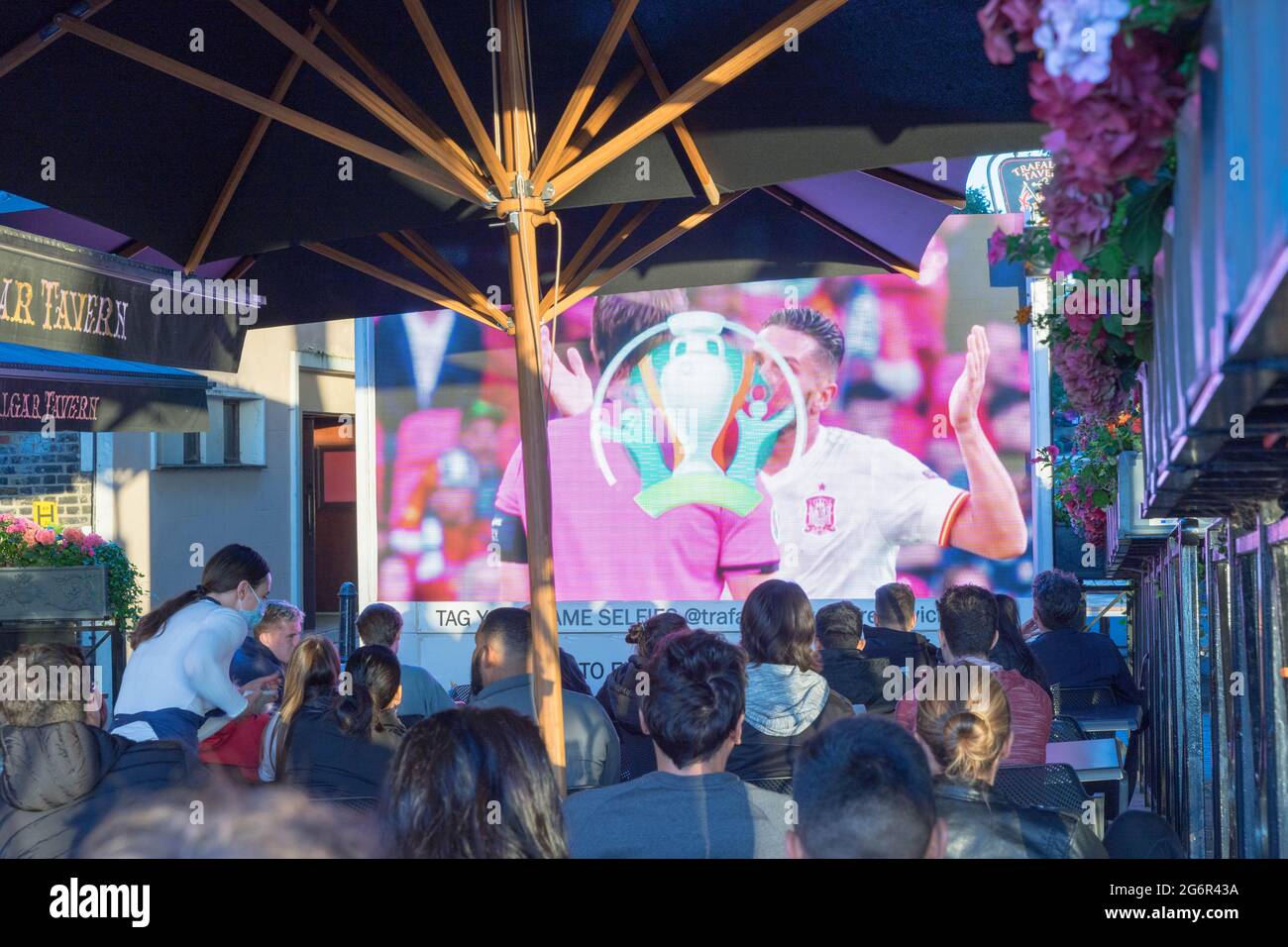 people watching euro 2020 football match at outdoor pub seating, London ...