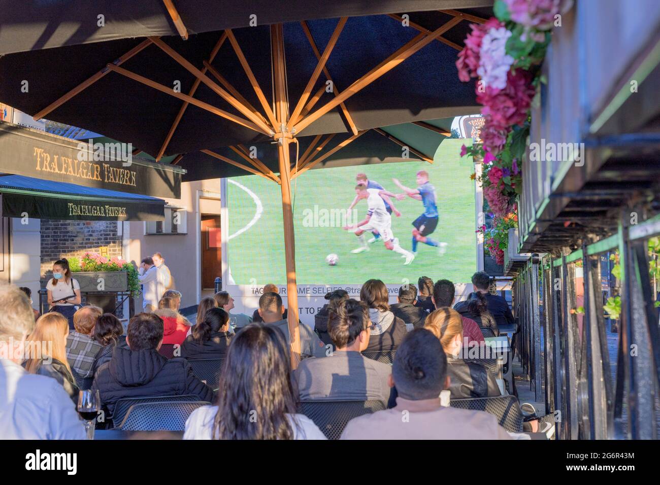 people watching euro 2020 football match at outdoor pub seating, London ...