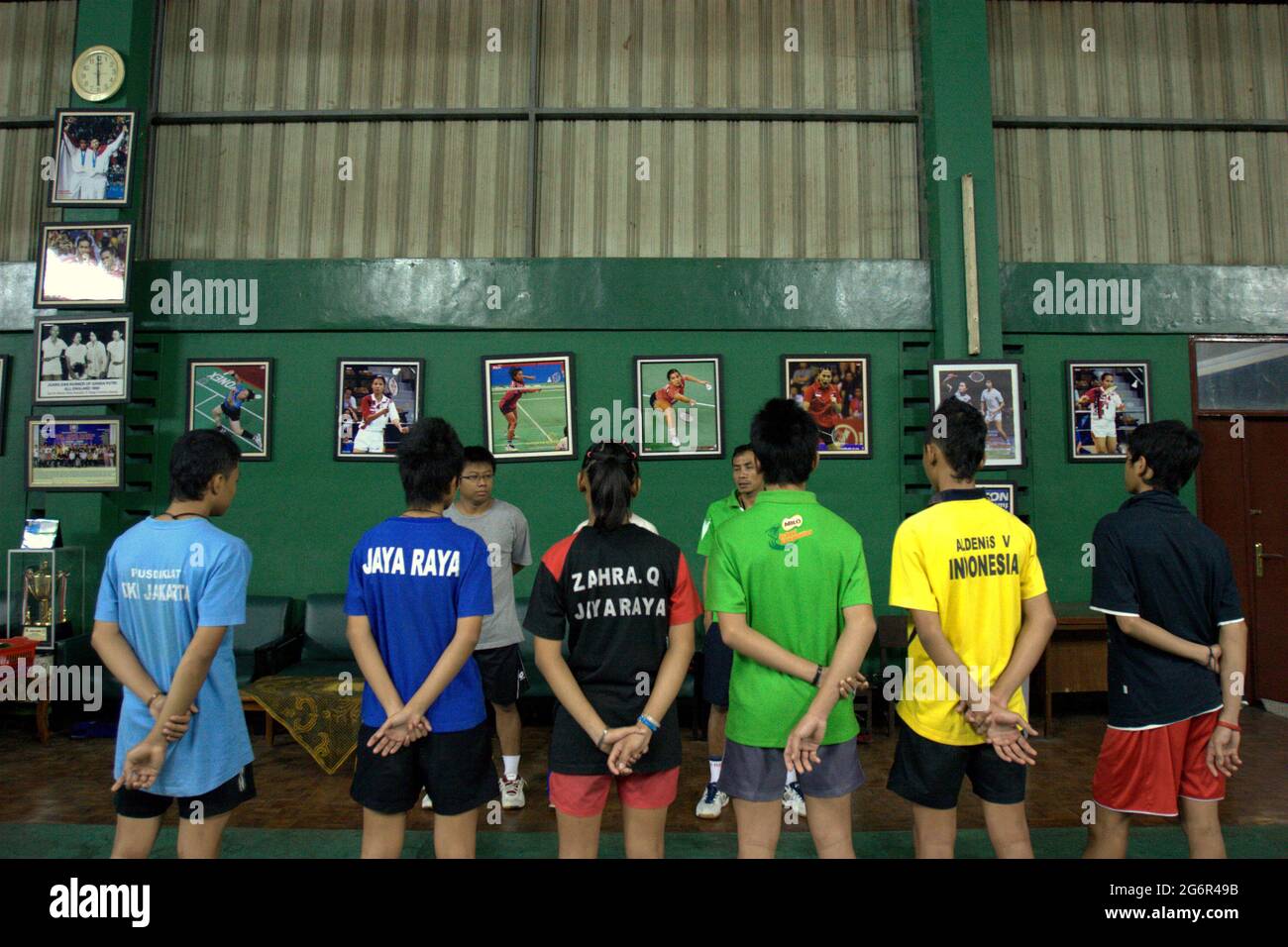 Young badminton players are given instructions during a training ...