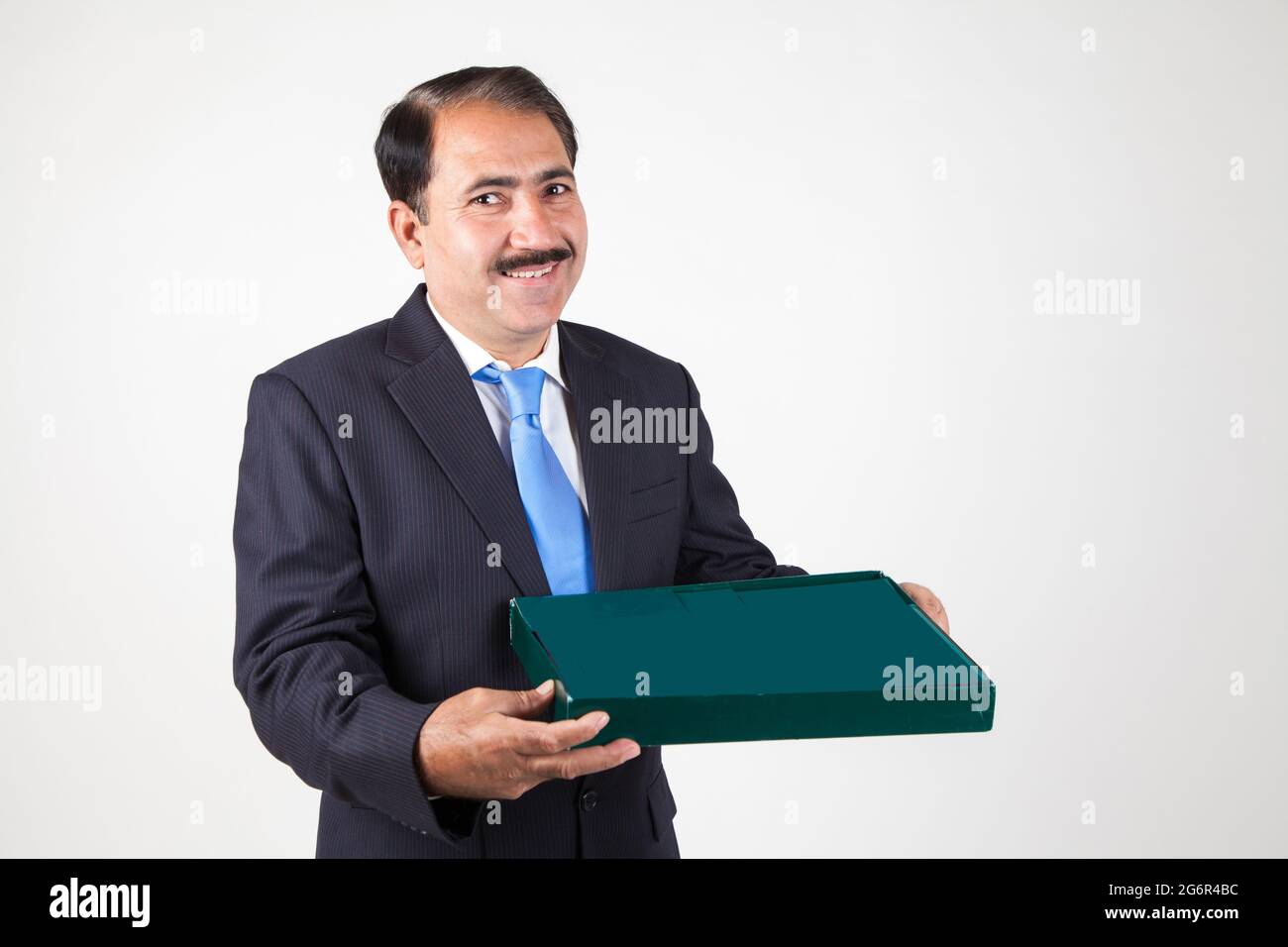 Mature CEO businessman holding closed box with money Stock Photo - Alamy