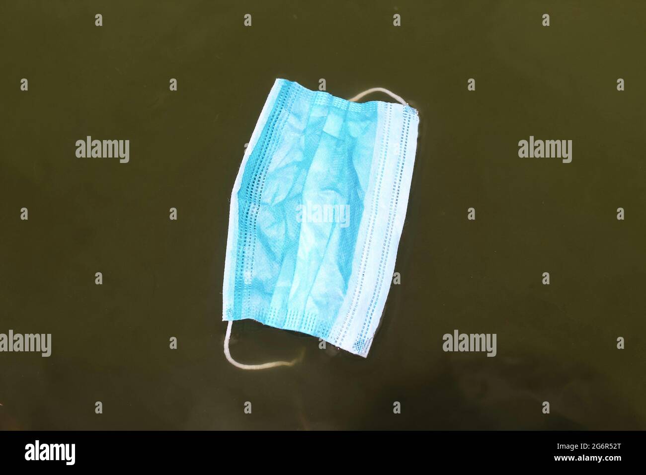 surgical mask threw into the sea. The image about ocean pollution and ...