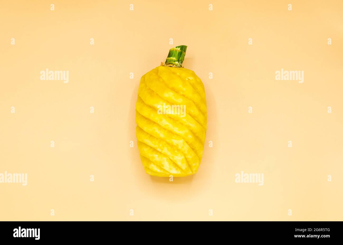 Peeling fresh pineapple on beige background Stock Photo - Alamy