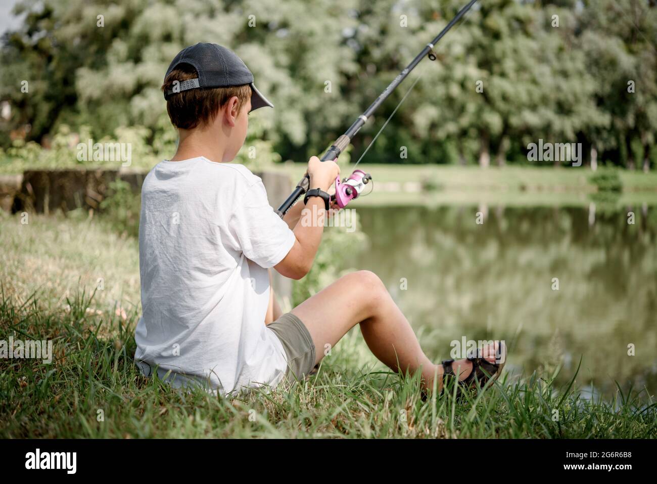 Children reel in fish lake hi-res stock photography and images - Alamy