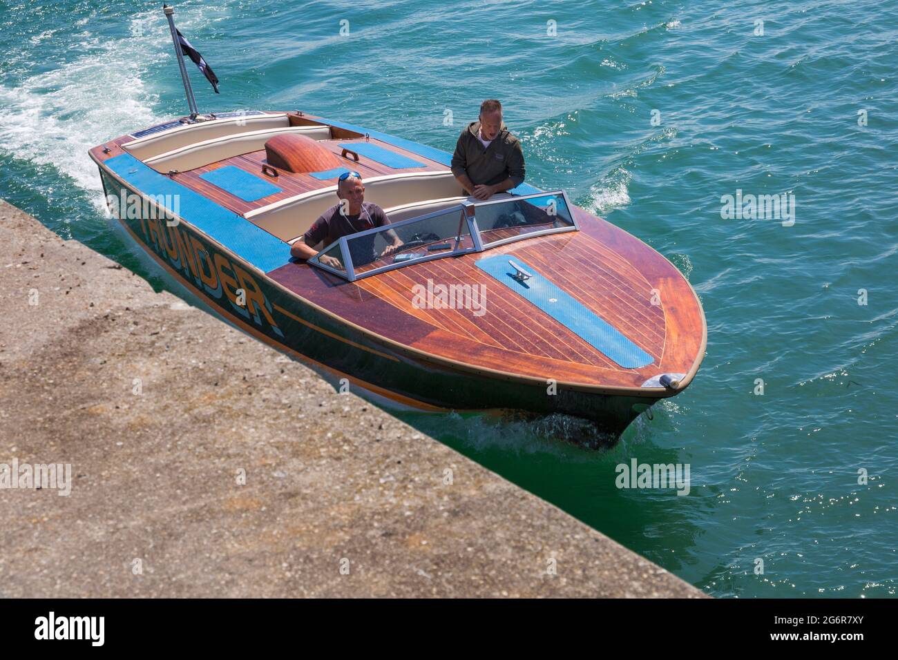 Two men on board Thunder speedboat at Padstow, Cornwall UK in June ...