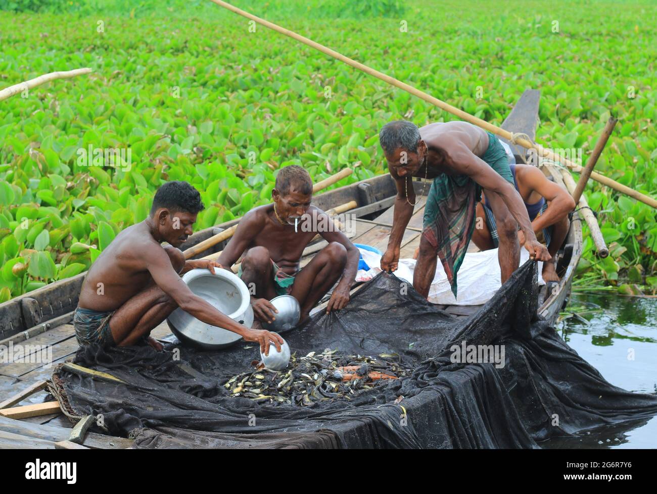 Bangladeshi fisherman caught fish. Fish on hand. Fishing on the river ...