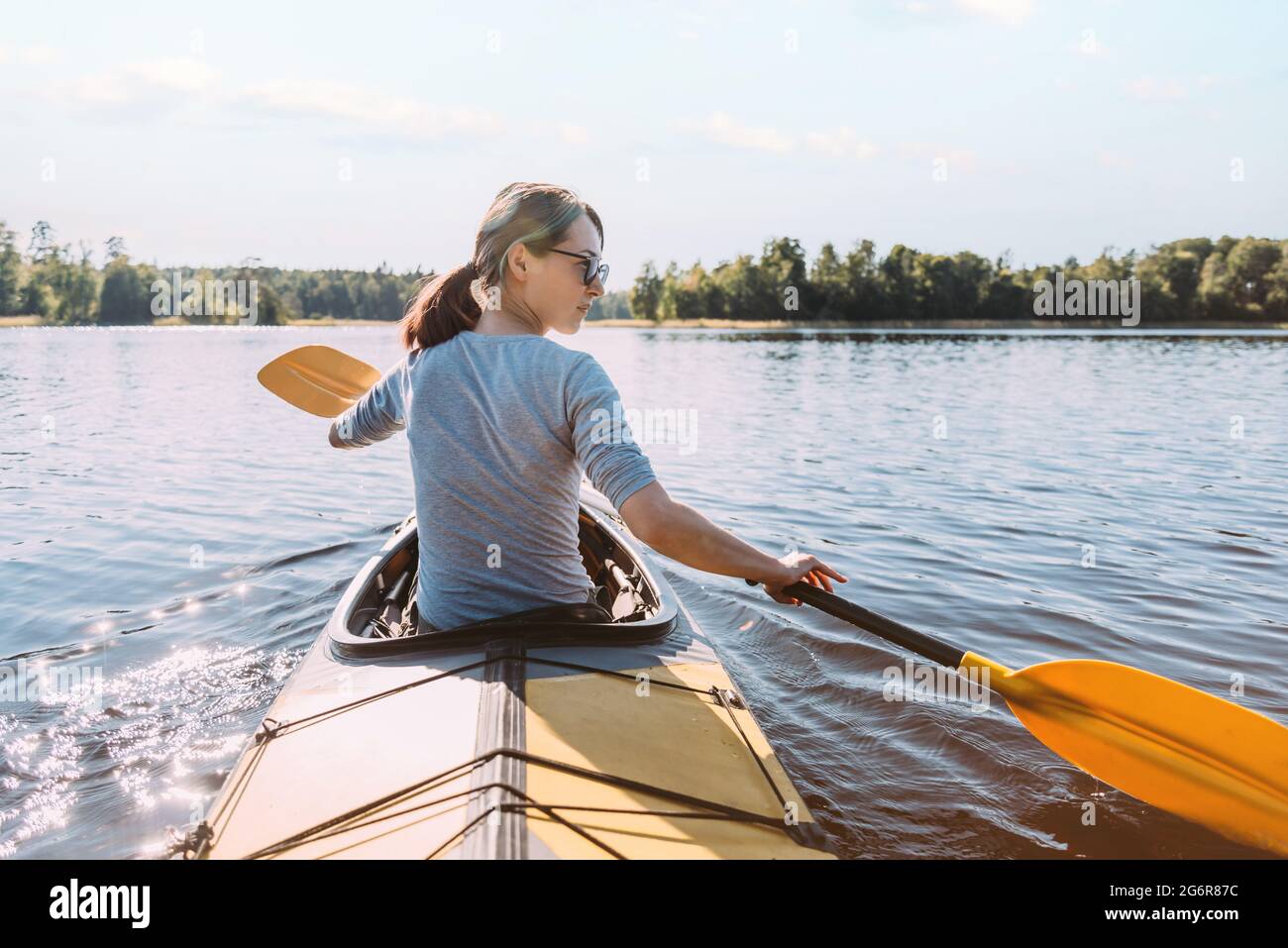 View from the back, a woman on a boat Stock Photo - Alamy
