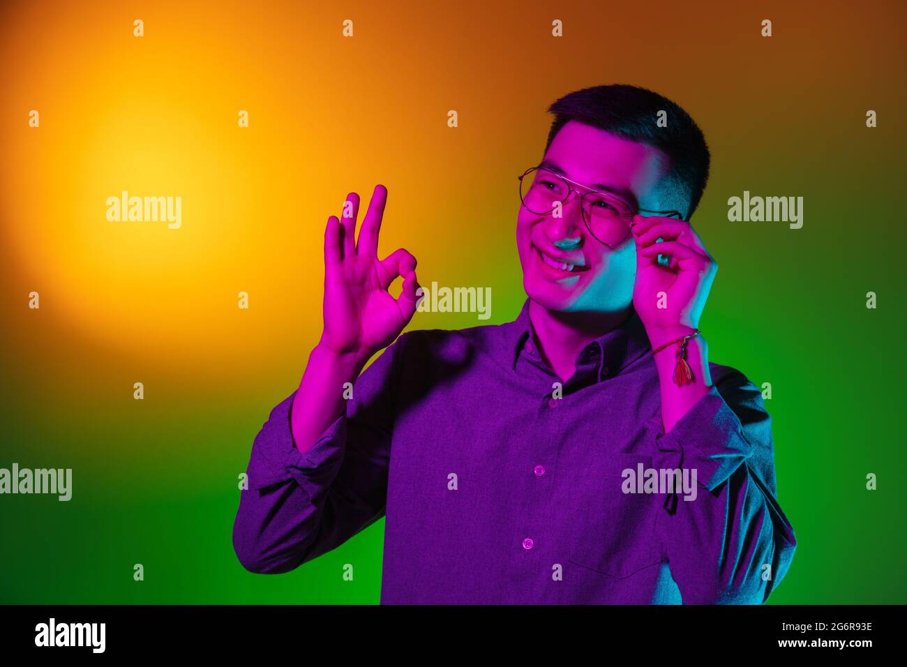 Portrait of Asian young man isolated on studio background in gradient ...