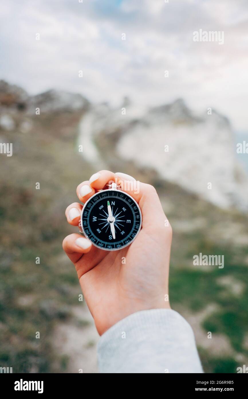 Woman hiker with a compass in her hands and a beautiful manicure Stock ...