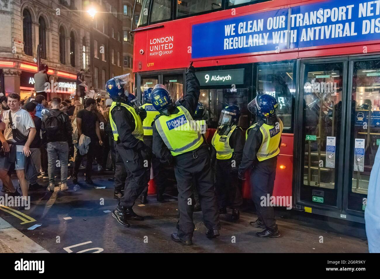London, UK. 07th July, 2021. Riot police protect a bus after England ...