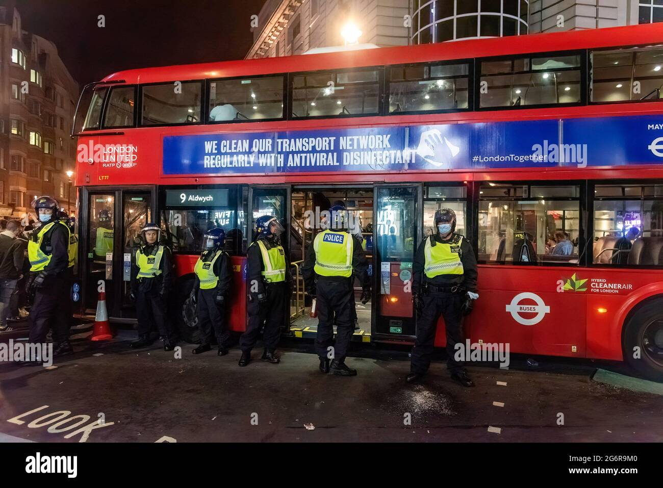 London, UK. 07th July, 2021. Riot police protect a bus after England ...