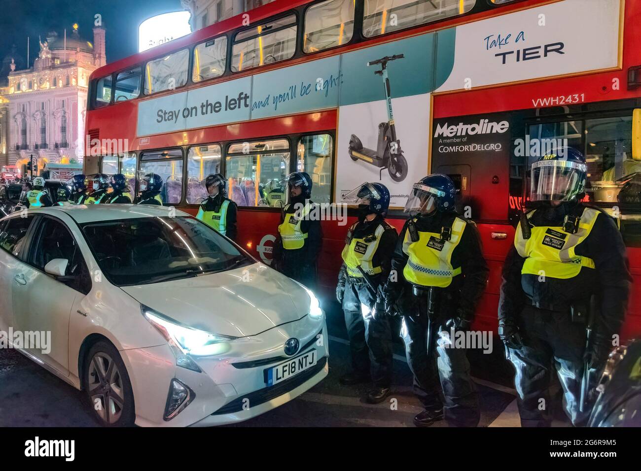 London, UK. 07th July, 2021. Riot police protect a bus after England ...