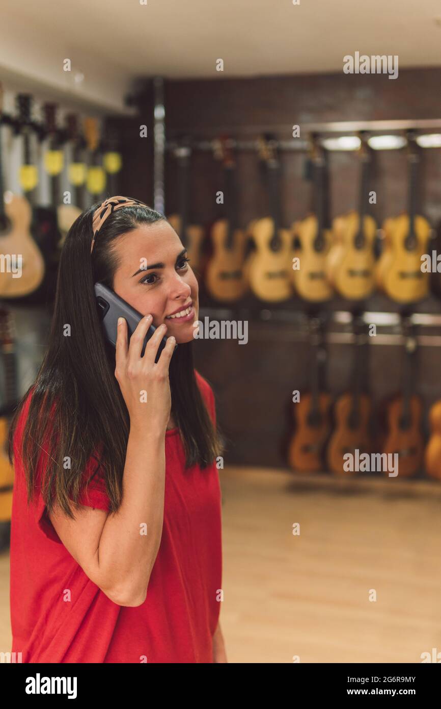 Positive beautiful female holding mobile hi-res stock photography and ...