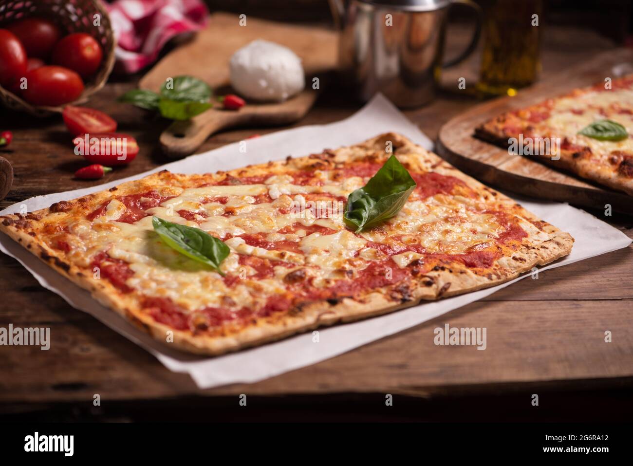 Rectangular shape home made pizza on rustic table with mozarella tomato ...