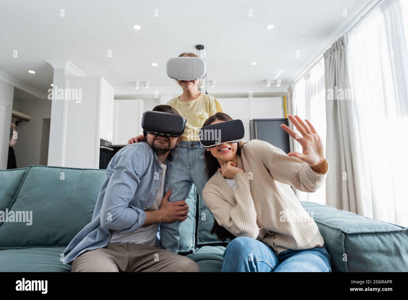 scared family gaming in vr headsets at home Stock Photo - Alamy