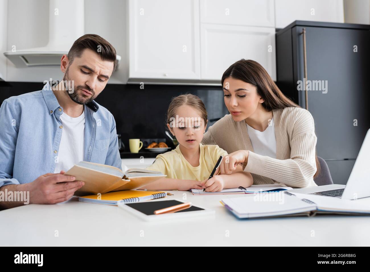 Reading helping girl kid child book pointing hi-res stock photography ...