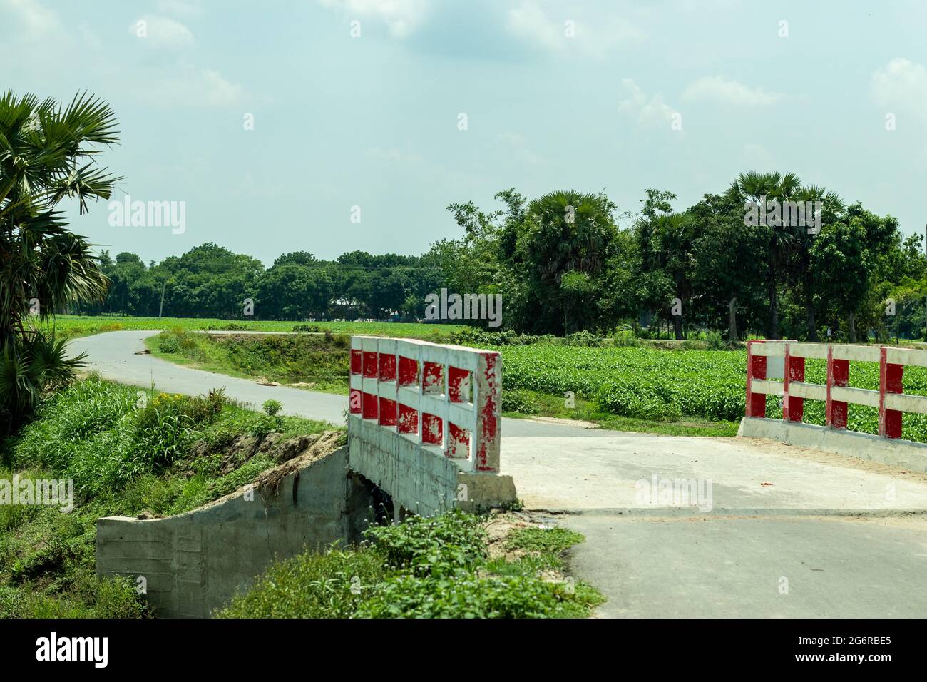 A beautiful bridge in the middle of the secluded village road and jute ...