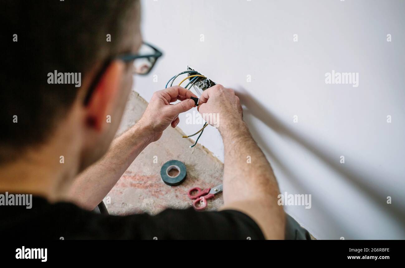 Electrician working on the electrical installation of a house Stock ...