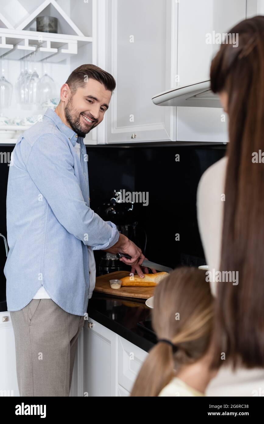 Happy woman cutting fresh bread hi-res stock photography and images - Alamy