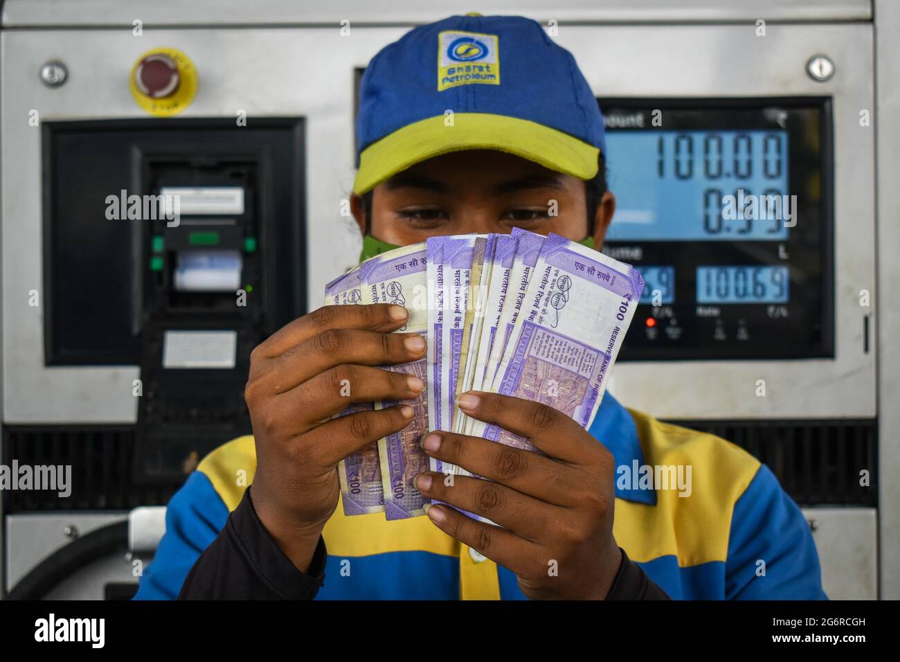 An employee counts money during the high price rate of fuel at a fuel ...