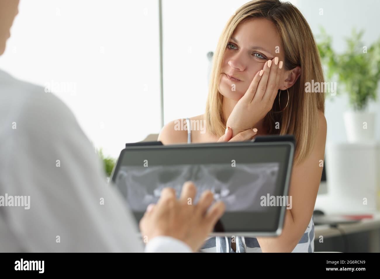 Female patient with acute toothache at doctor appointment with X-ray ...