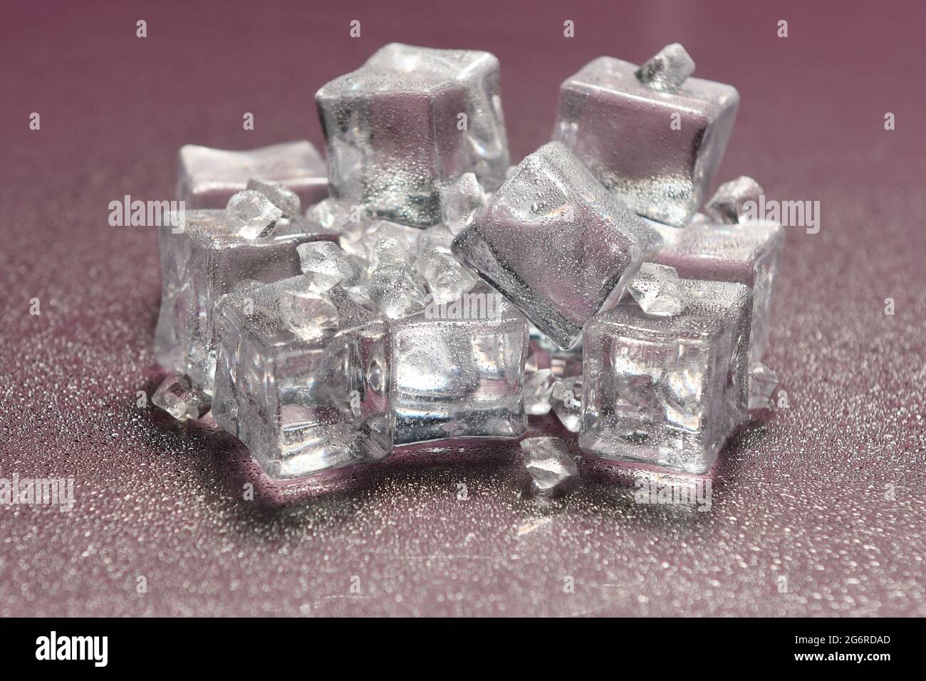 ice stone on reflective surface of background with drops, idea of a ...